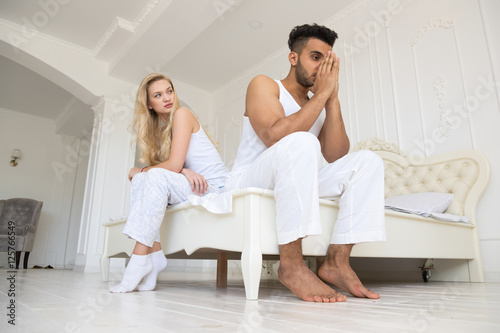 Young Couple Sitting Separate On Bed Having Conflict Relationships