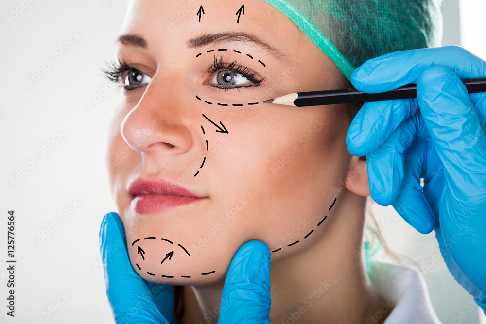 Surgeon Drawing Lines On Woman's Face For Plastic Surgery Stock Photo ...
