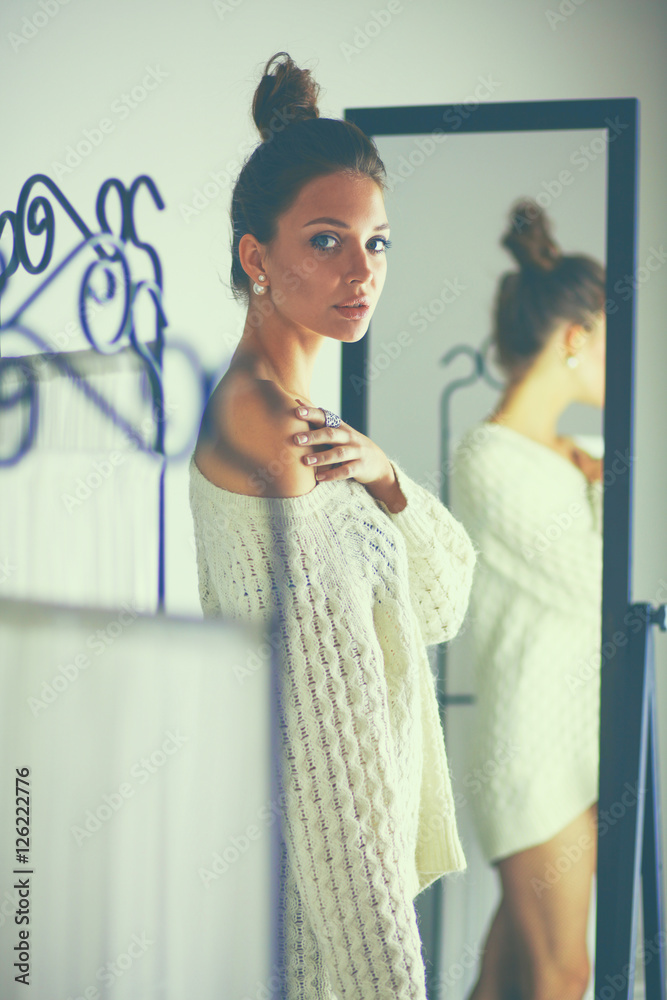 Portrait of a cute woman in sweater at home Stock Photo | Adobe Stock