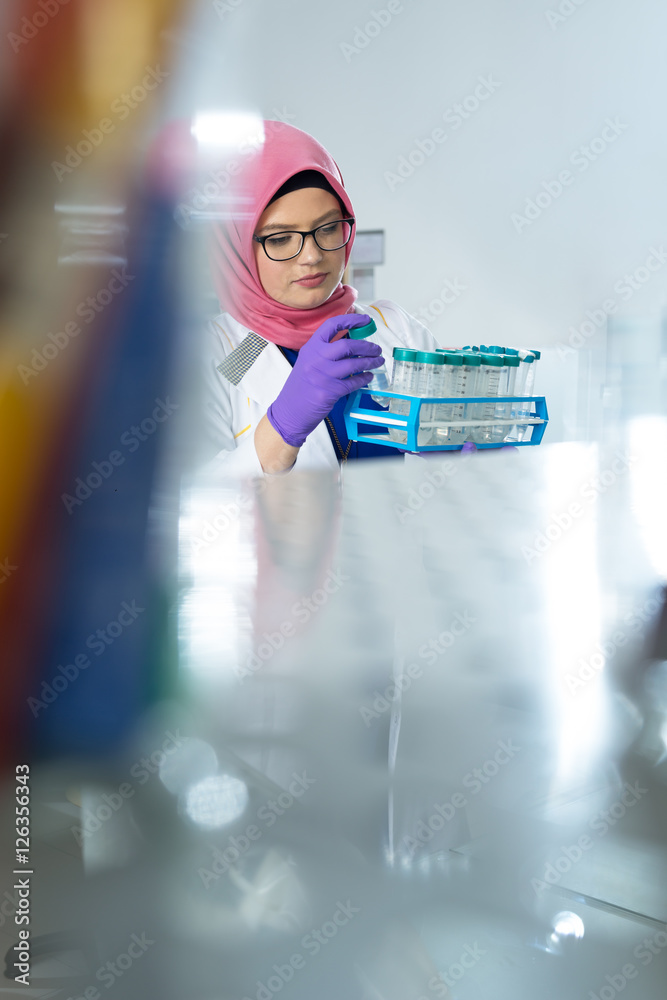 muslim lab worker with hijab or researcher doing an analysis in Stock ...