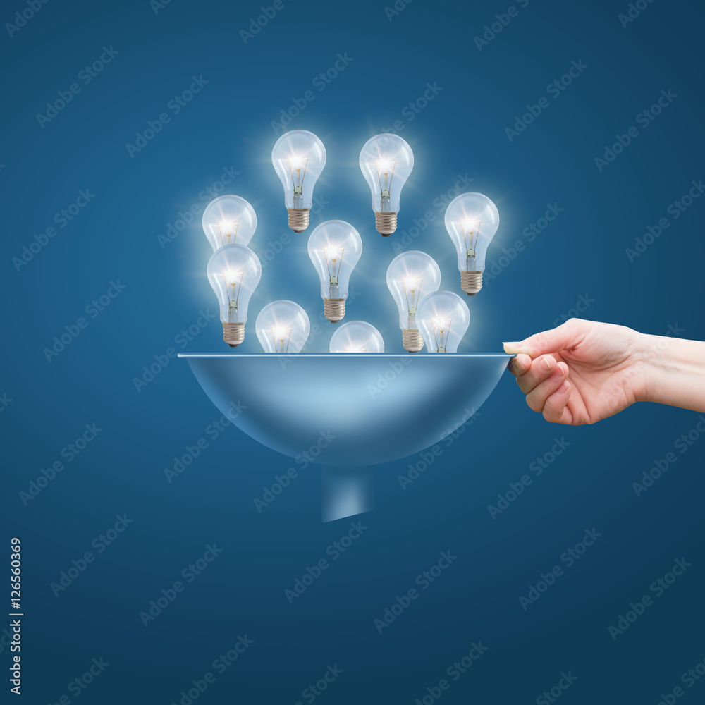 Foto de Stock Hand with a funnel and a lot of bulbs, the concept of ...