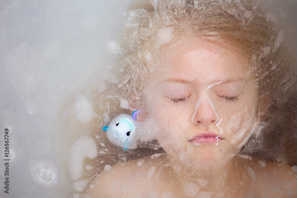 Girl with head underwater in bath Stock Photo | Adobe Stock