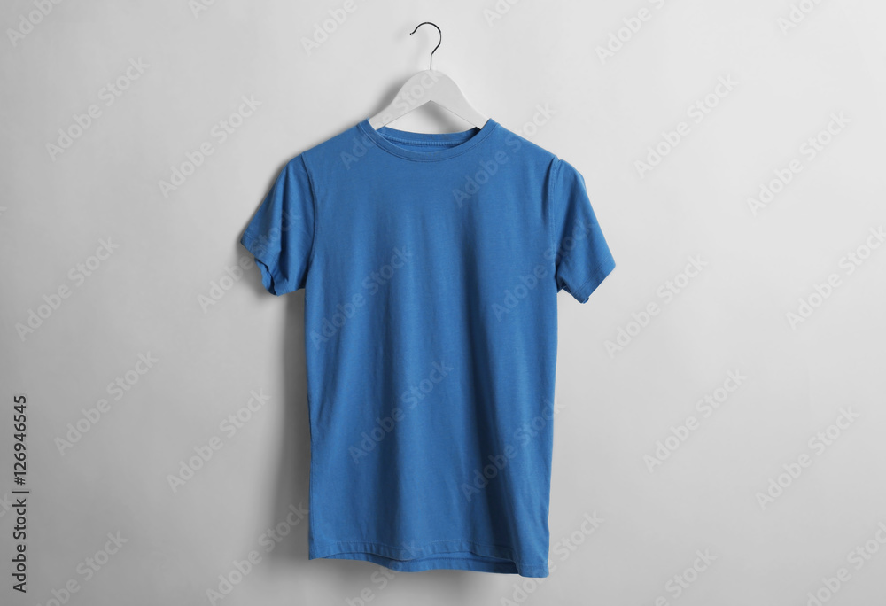 Blank blue t-shirt on light background Stock Photo | Adobe Stock