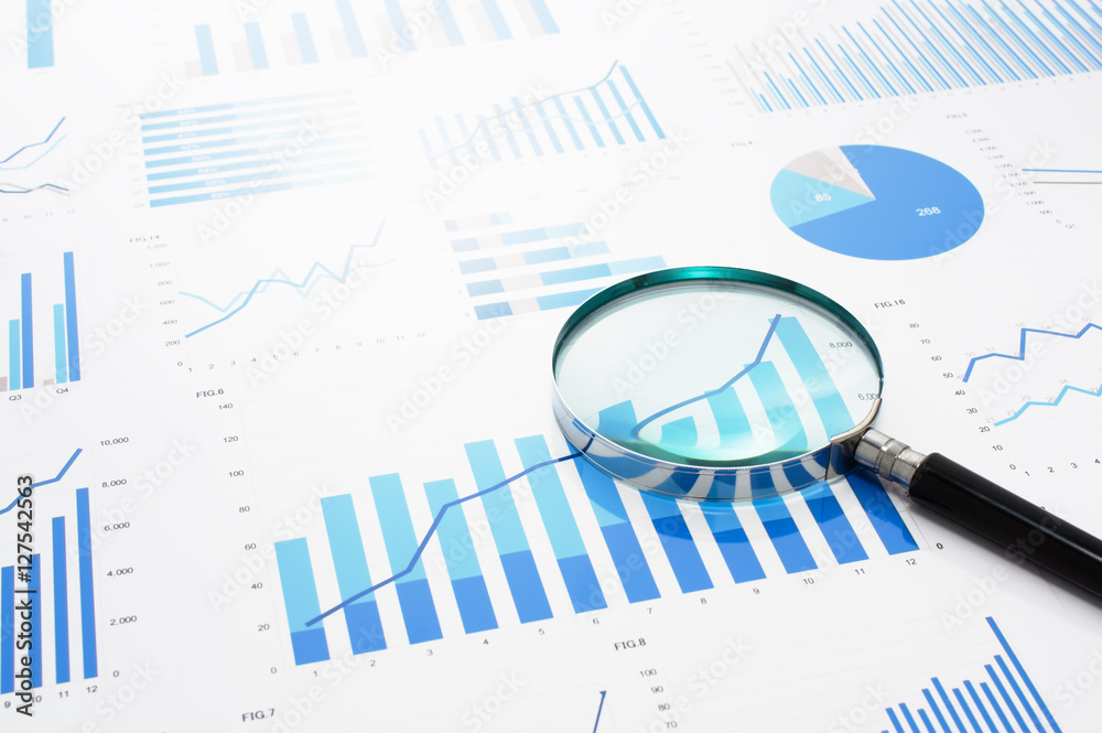 Many charts and magnifying glass. Reviewing data. Financial reports and ... Many charts and magnifying glass. Reviewing data. Financial reports and ...