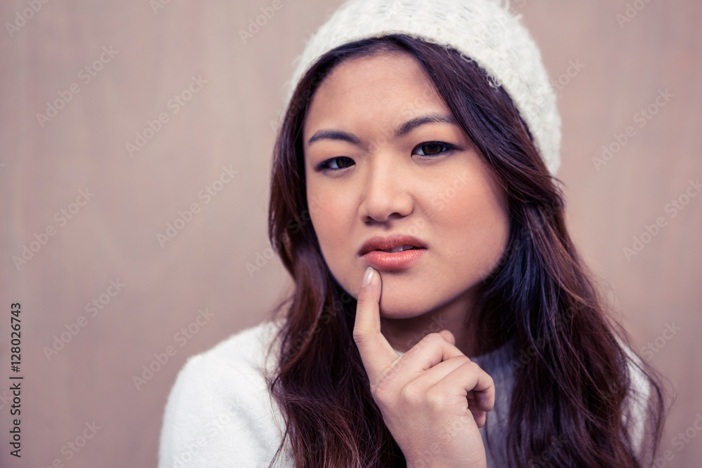 Thoughtful woman with finger on chin Stock Photo | Adobe Stock