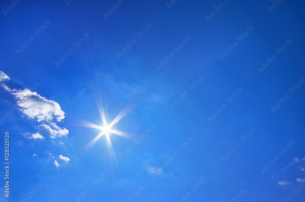 Deep blue sky. Six point sun and clouds Stock Photo | Adobe Stock