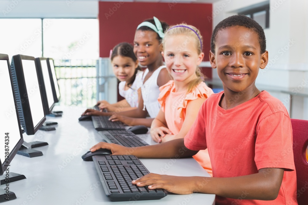 School kids using computer in classroom Stock Photo | Adobe Stock