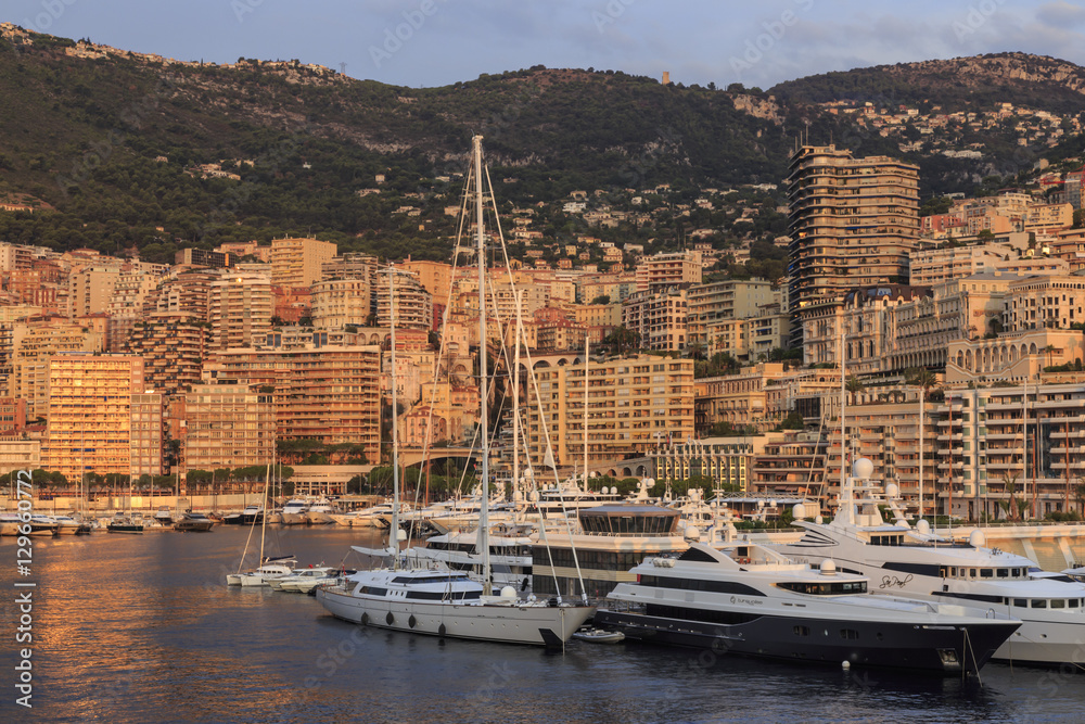 Yachts in the glamorous Port of Monaco (Port Hercules) at sunrise, from ...