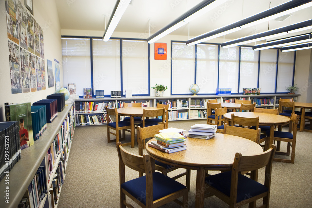 Tables and chairs arranged in an empty high school library Stock Photo ...