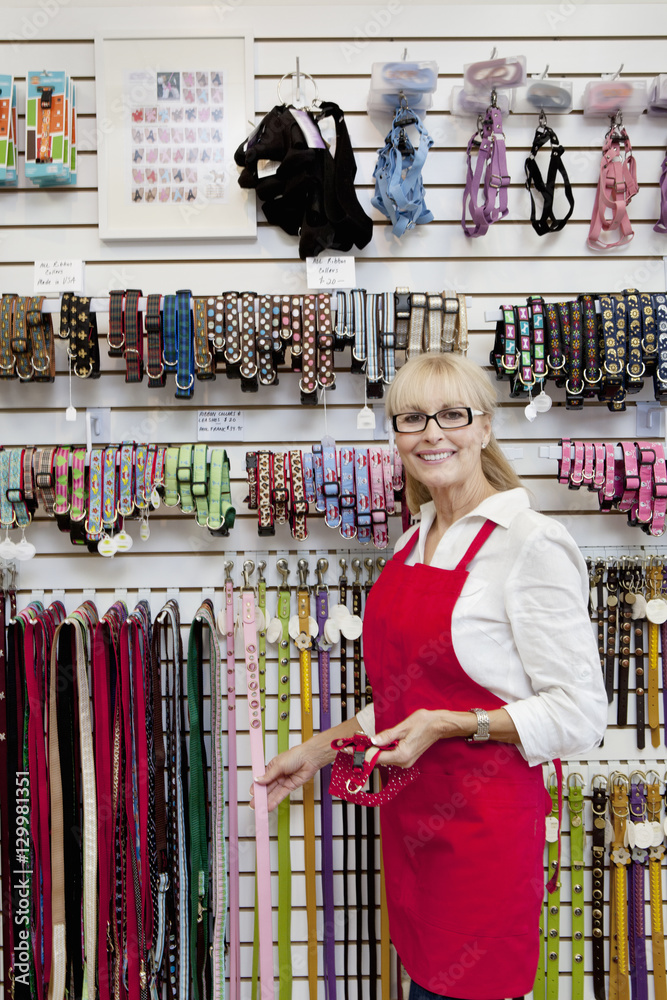 Portrait of senior owner of pet shop showing belt Stock Photo | Adobe Stock
