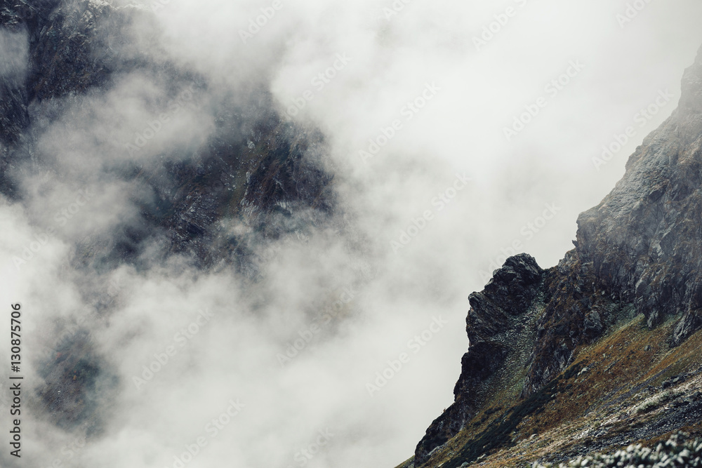 Rock in mist and clouds. Minimalistic Photo with film effect and ...