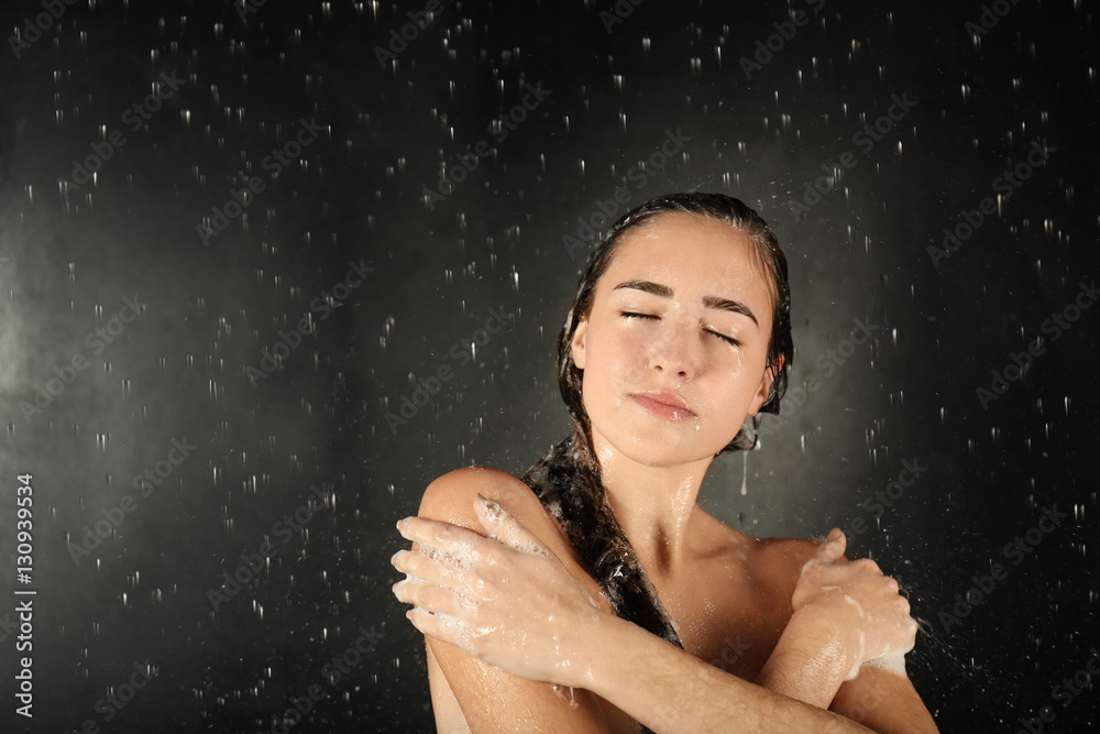 Beautiful young woman washing body in a shower Stock Photo | Adobe Stock