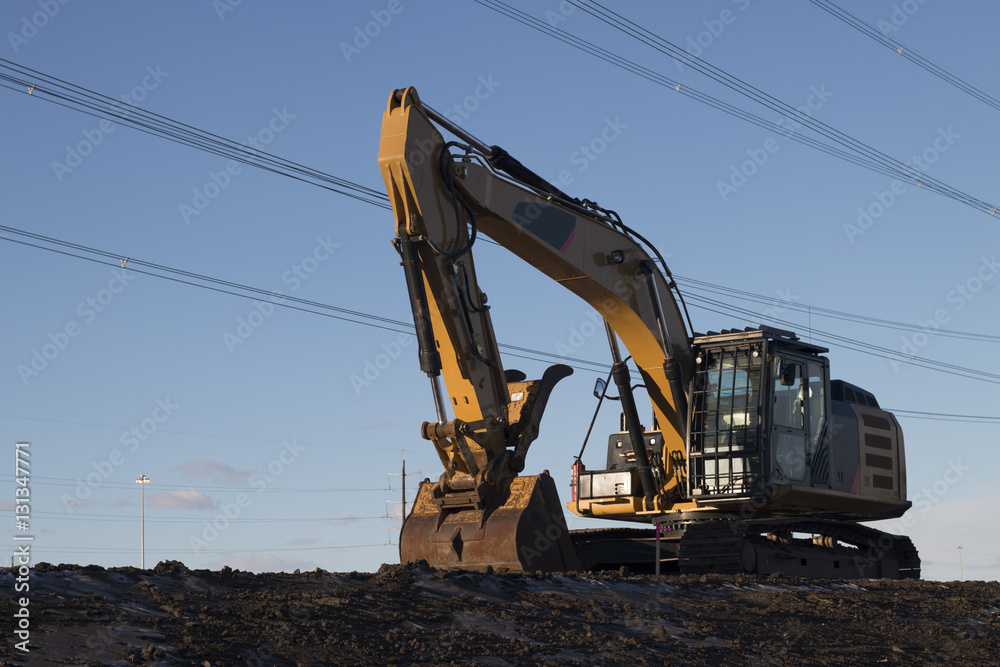 Excavator Parked Under Power Lines on a Construction Site Stock Photo ...