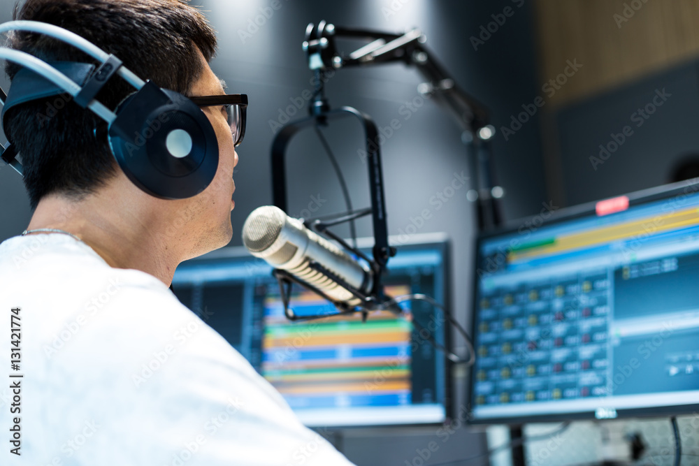 young man dj works in modern broadcast studio Stock Photo | Adobe Stock