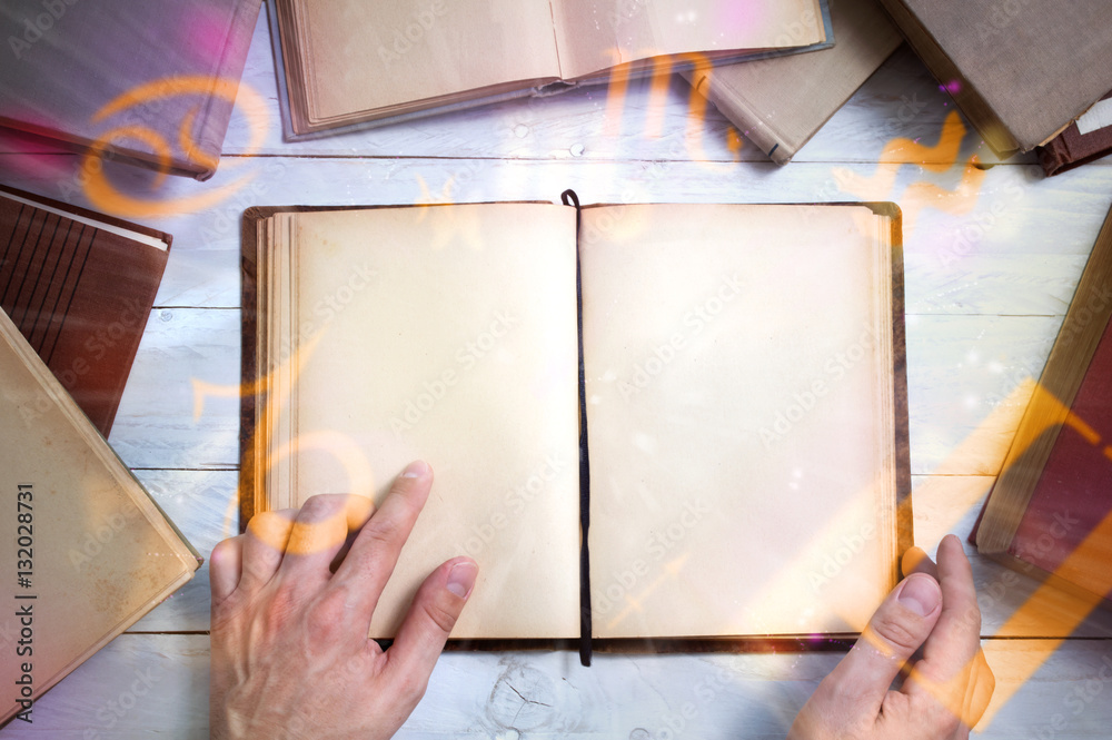 Old magic book with glowing zodiac symbols and empty pages for your ...