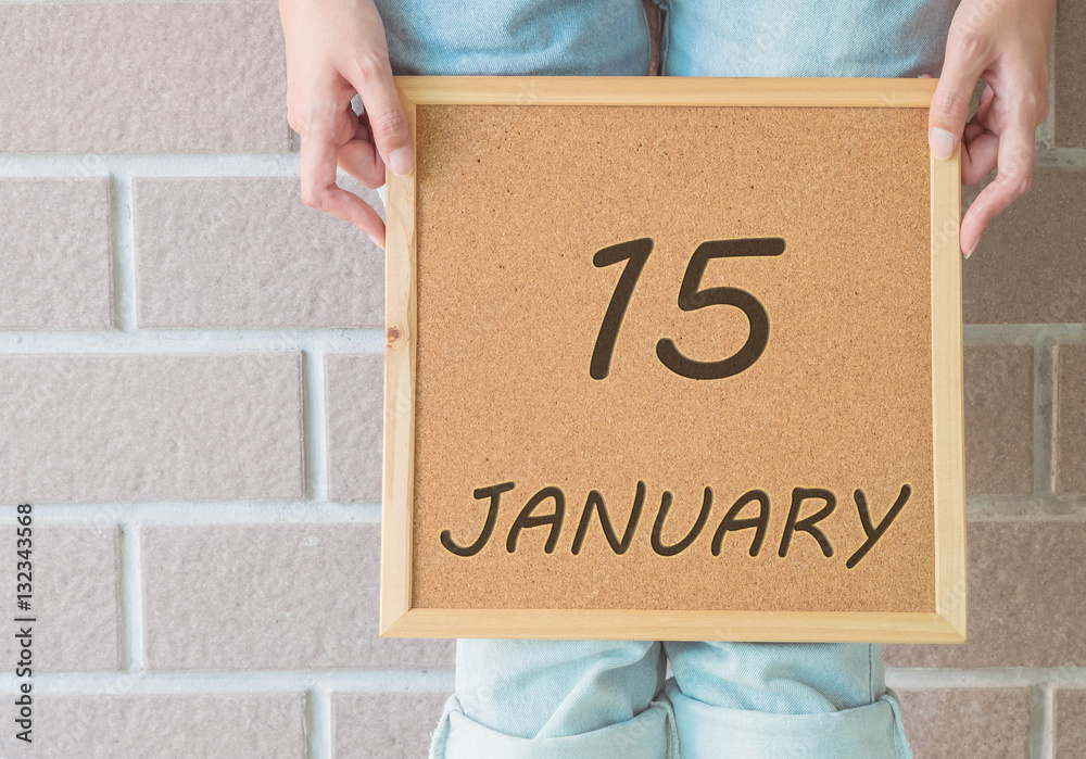Closeup calendar at the cork board in hand of asian woman in front of ...