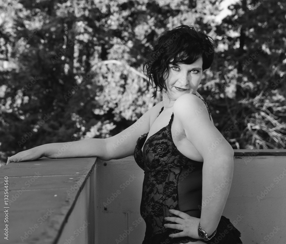 Curvy model in intimate clothing poses outdoors with a sexy and ...