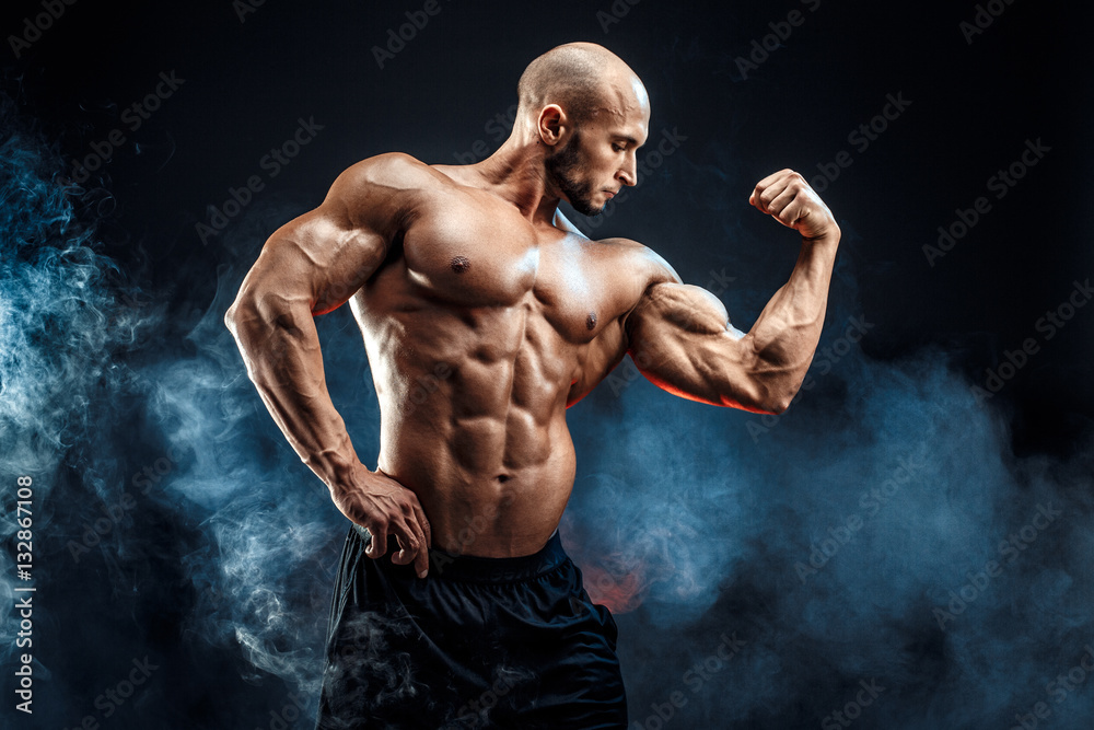 Strong bald bodybuilder with six pack. Bodybuilder man with perfect abs ...