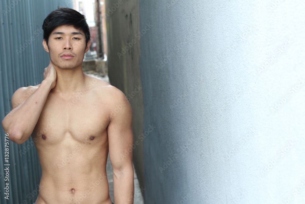 Sensual young Asian man with muscular torso and v shape with copy space ...