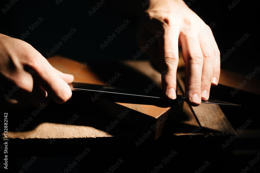 Person sharpening blade of knife, close up Stock Photo | Adobe Stock
