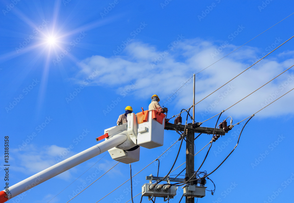 Electricians repairing wire of the power line on bucket hydraulic ...