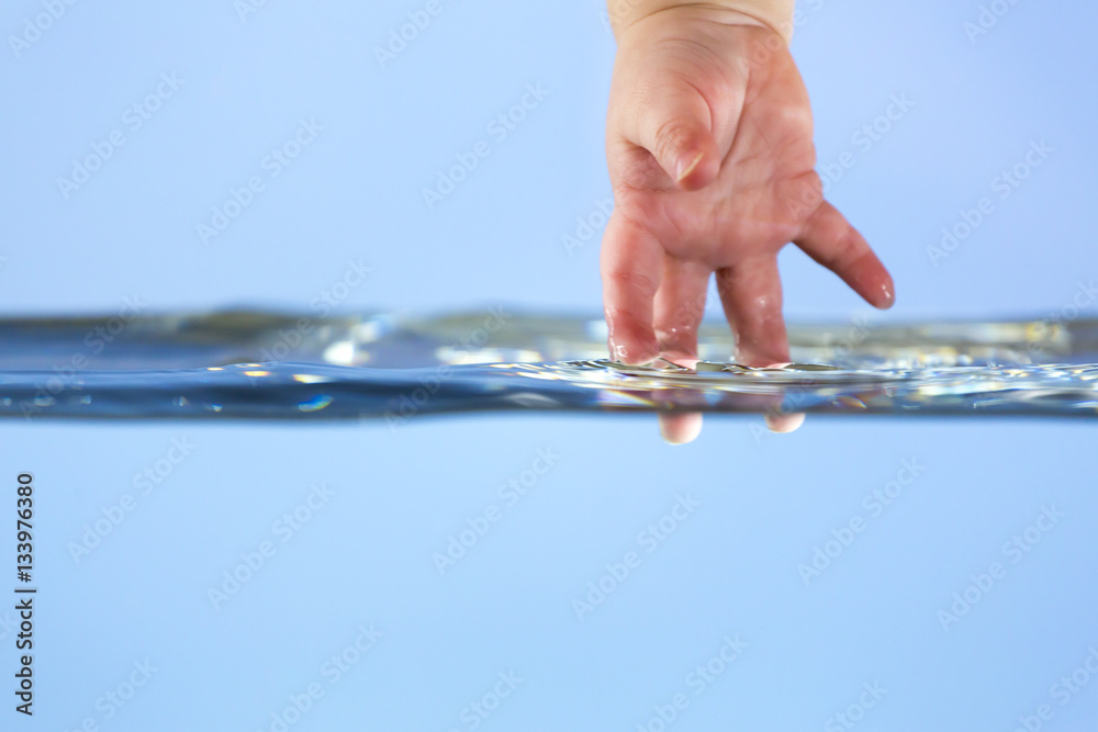 Baby touching water Stock Photo | Adobe Stock