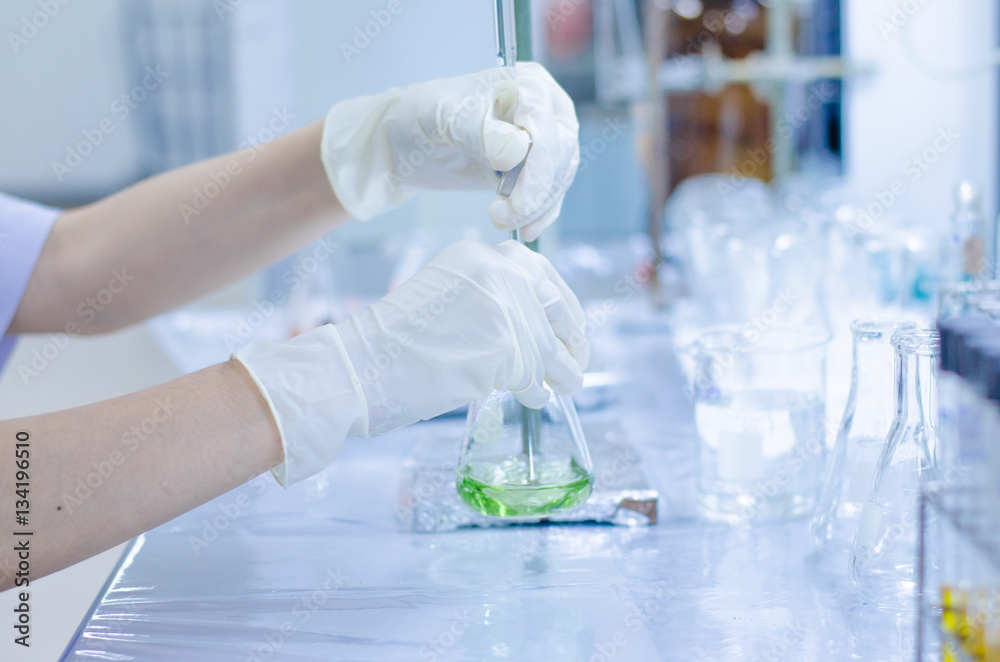 Scientist hand titration at laboratory, titrate chemical, titration ...