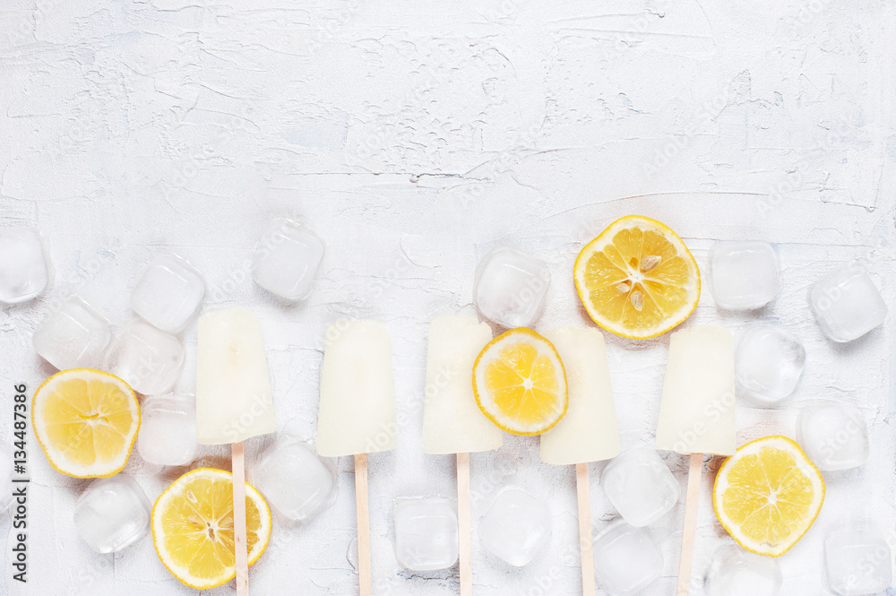 White background with lemon lollies, lemons and ice cubes Stock Photo ...