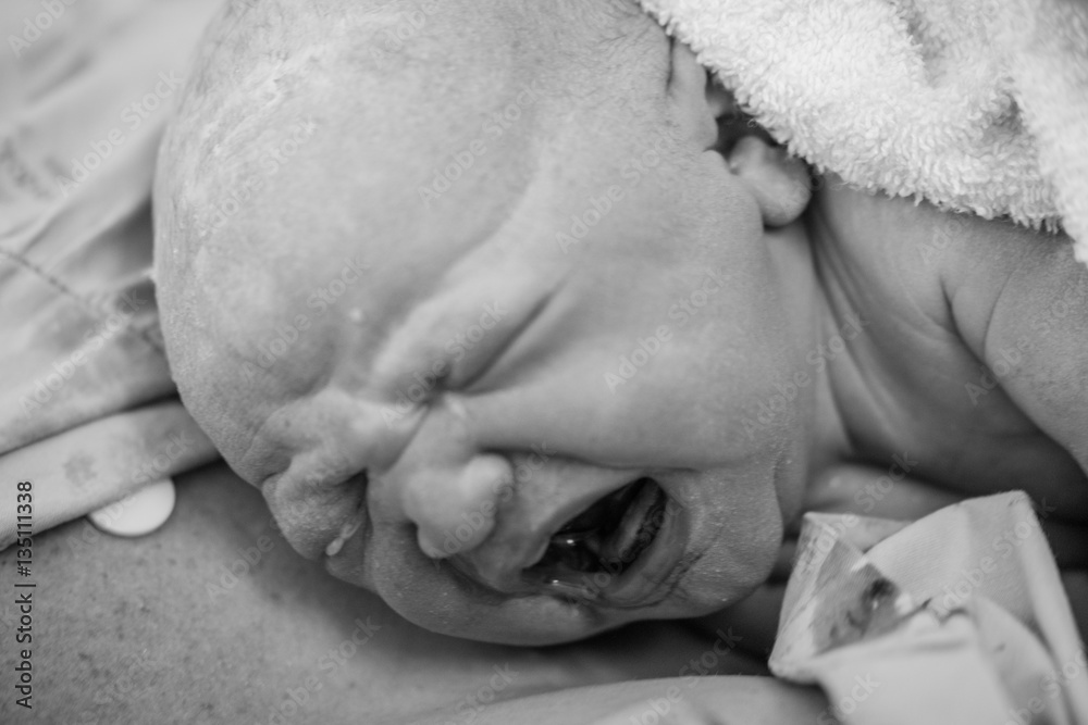 Freshly born baby skin to skin on mothers chest caucasian female ...