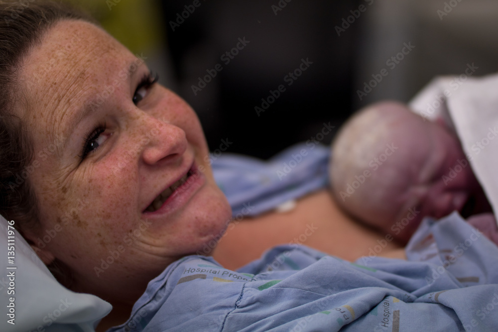 Freshly born baby skin to skin on mothers chest caucasian female ...