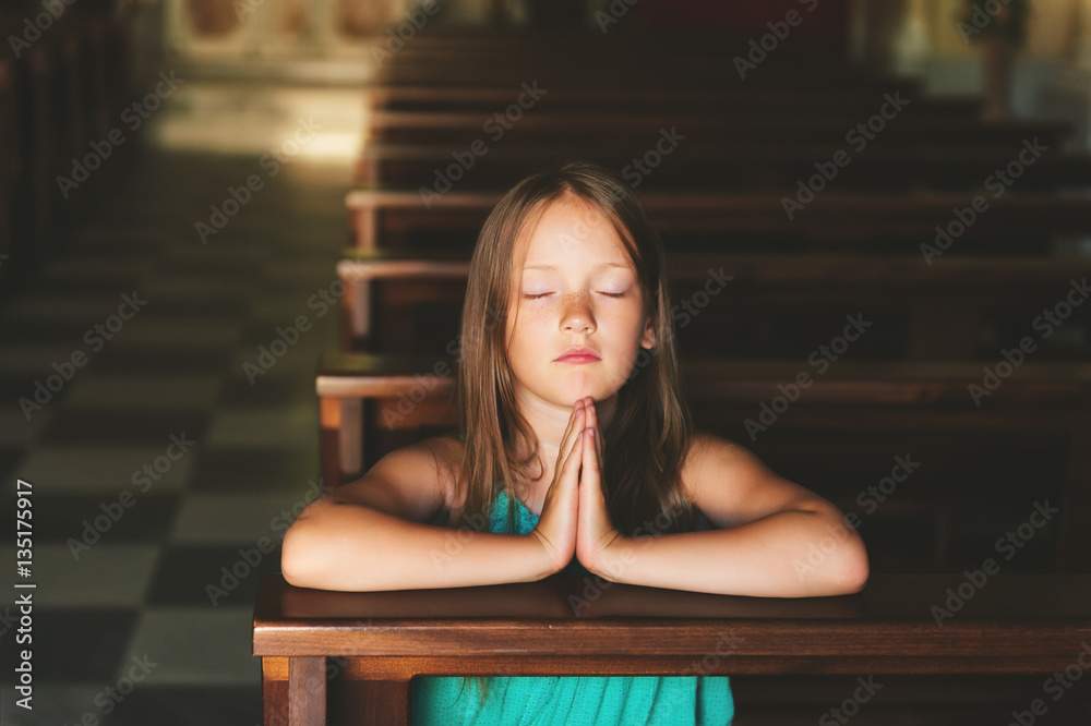 Child praying in church Stock Photo | Adobe Stock
