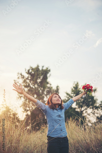 Beautiful Woman Hipster Raising Her Arm In The Air With Bouquet
