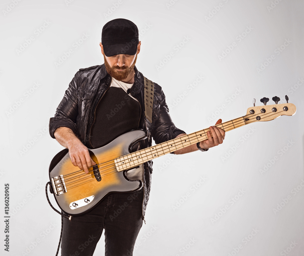 Bassist plays bass guitar. Stock Photo | Adobe Stock