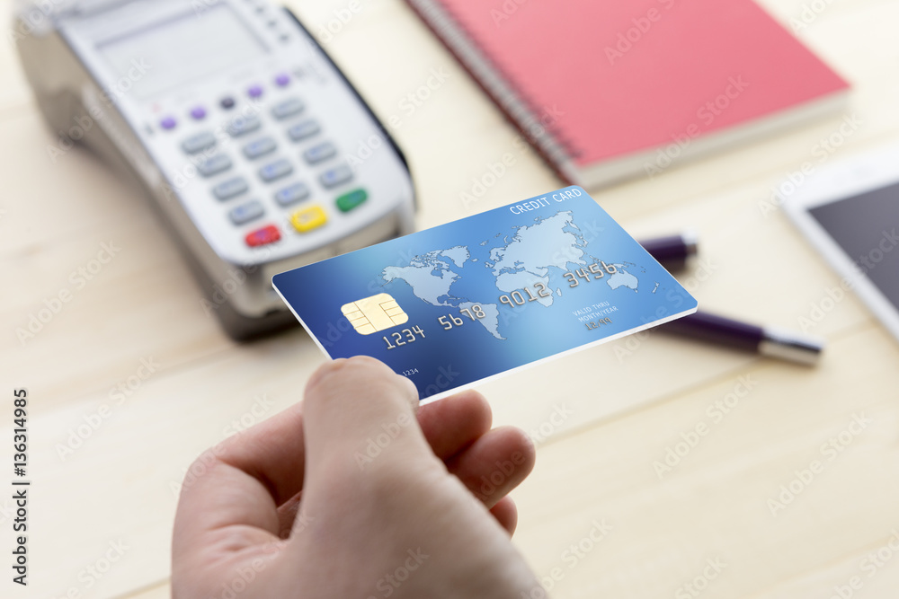 Cashier hand holding a Credit card over EDC machine or credit card ...