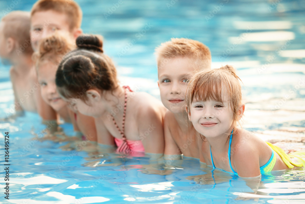Little kids in swimming pool on sunny day Stock Photo | Adobe Stock