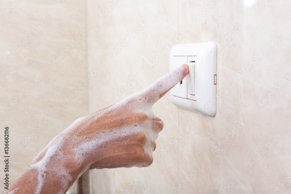 Wet hand of children trun on electric switch. Concept of do not use ...