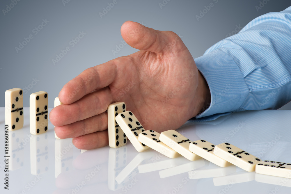 hand stopping domino falling sequence Stock Photo | Adobe Stock