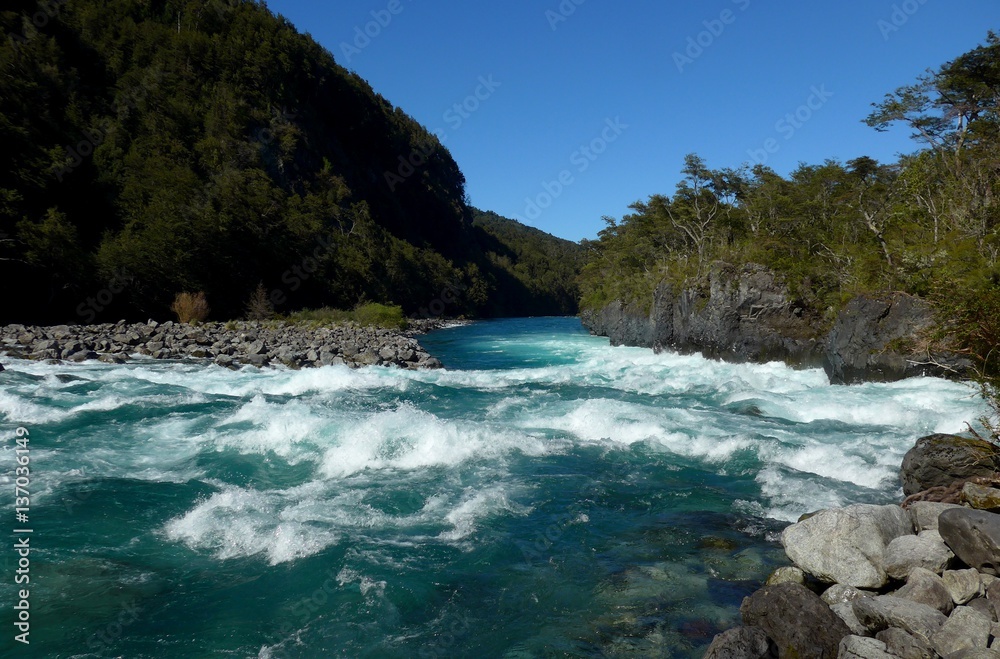 The stunning blue and white waters of the petrohue river near Saltos ...