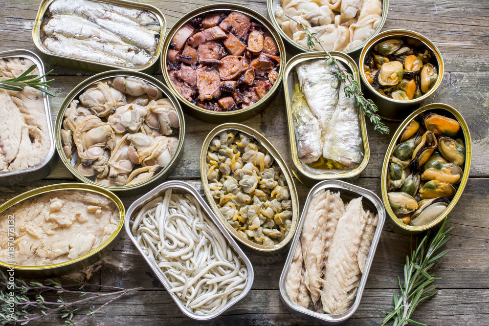 Assortment of cans of canned with different types of fish and seafood ...