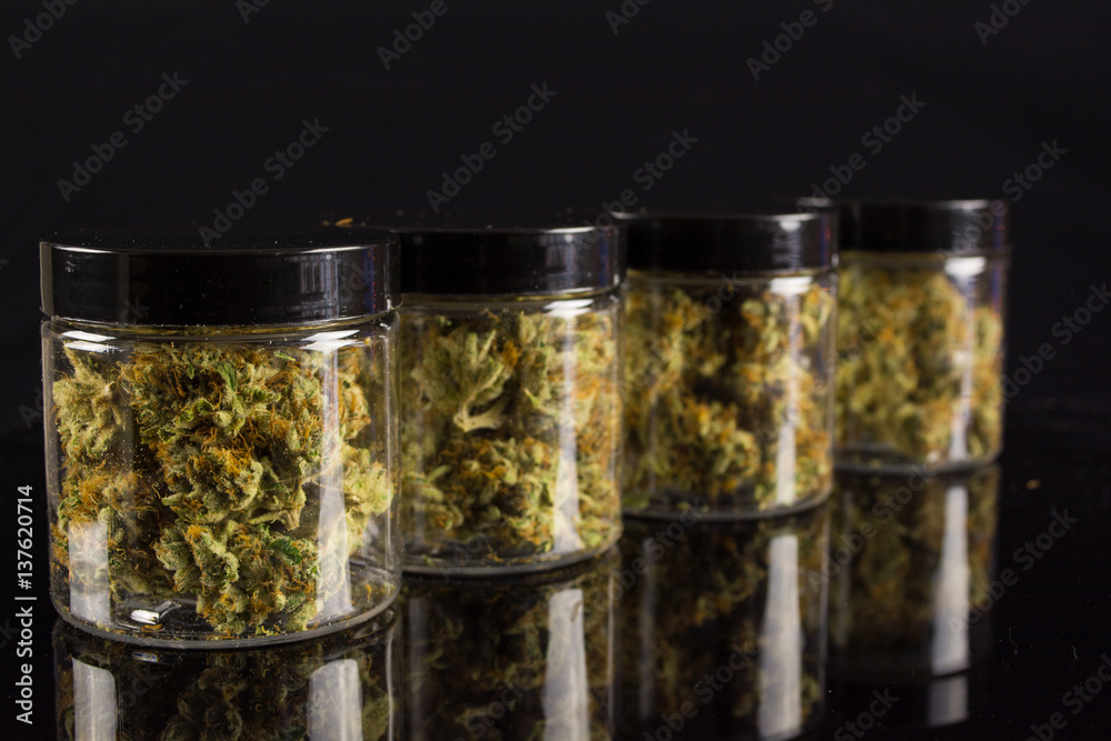 4 staggered quarter ounce jars of marijuana cannabis Stock Photo ...