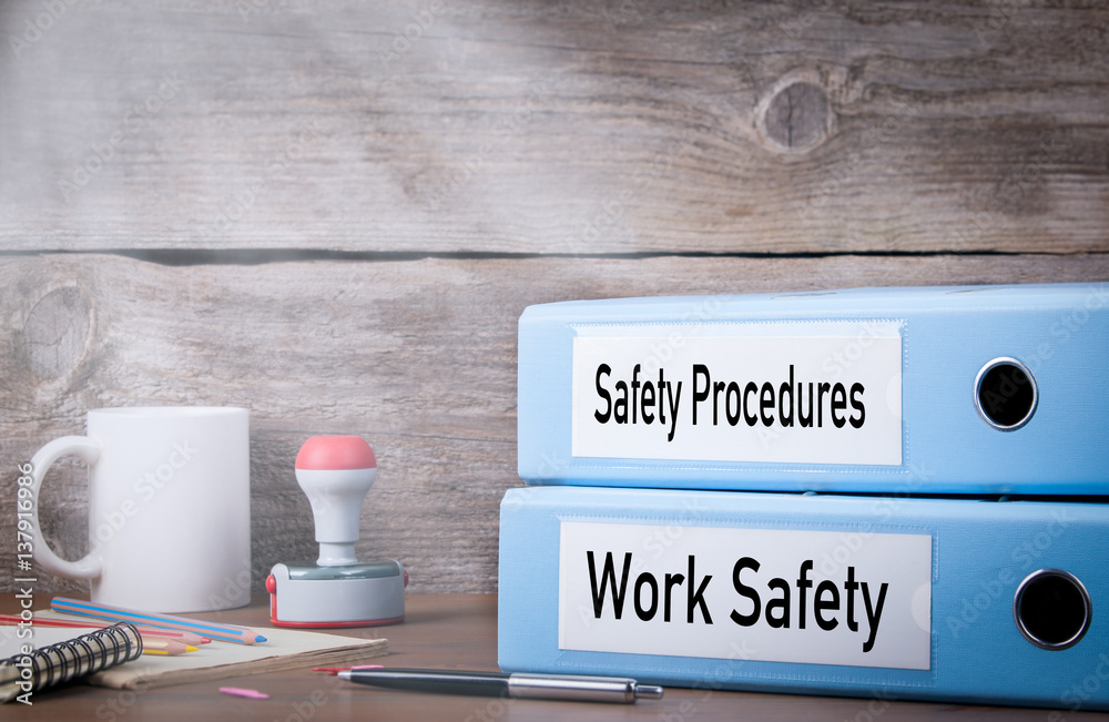 Work Safety and Safety Procedures. Two binders on desk in the office ...