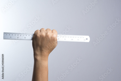 Hand holding a ruler Stock Photo | Adobe Stock