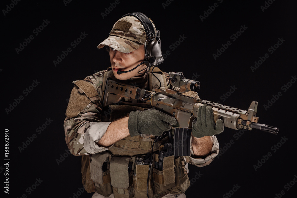 Portrait soldier or private military contractor holding sniper rifle ...