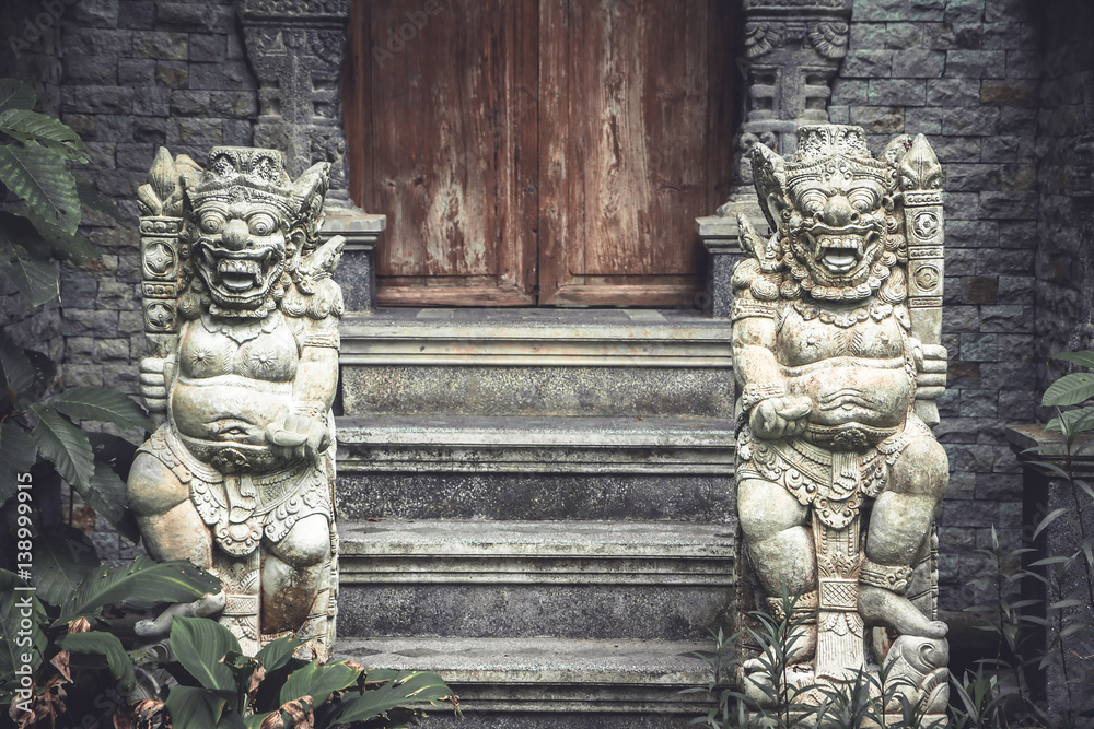 Ancient Asian demons deities at the enter to the old temple with old ...