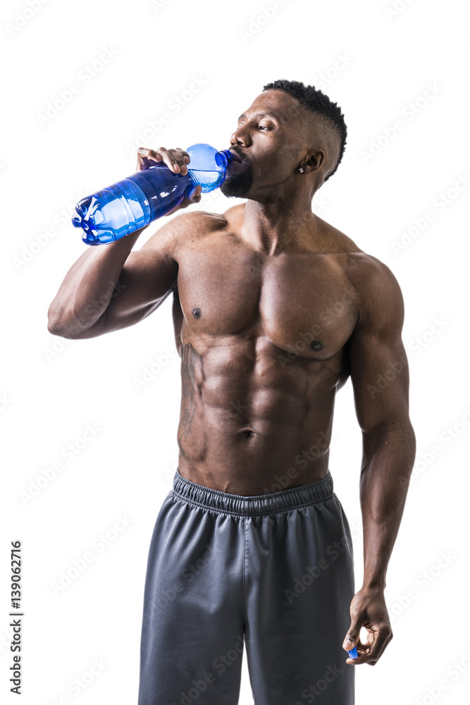 Muscular shirtless black male bodybuilder drinking water from plastic ...