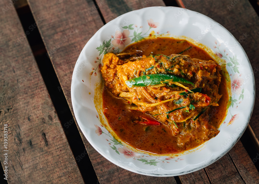 Vintage style Thai traditional food fried fish with red curry spell ...