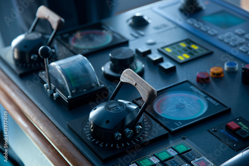 Engine, rudder and thruster control console on bridge of large modern ...