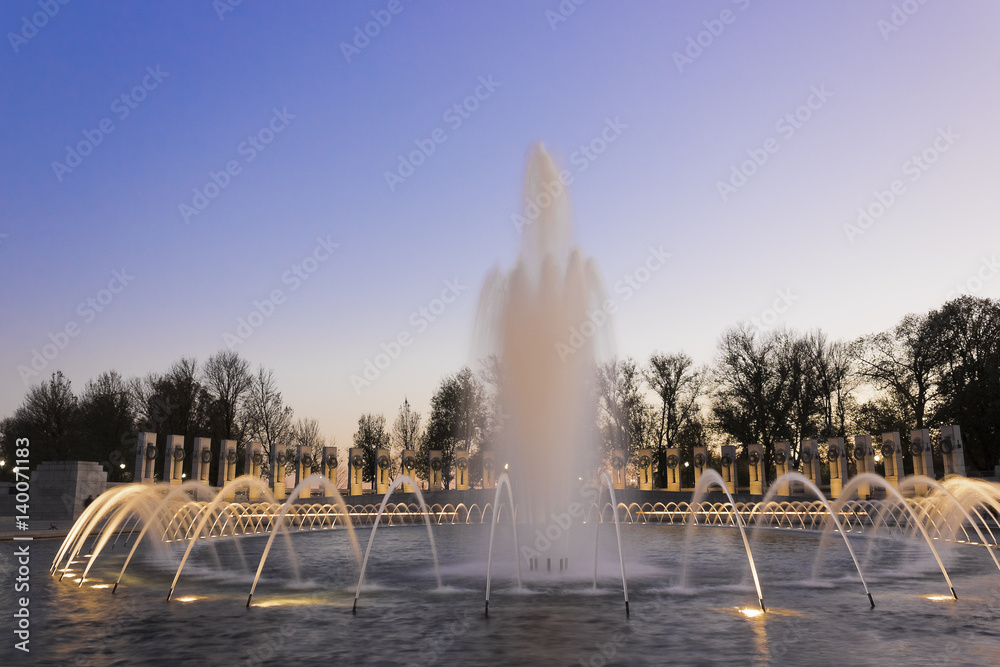 Night-time view of the north tall-fountain of the Rainbow Pool ...