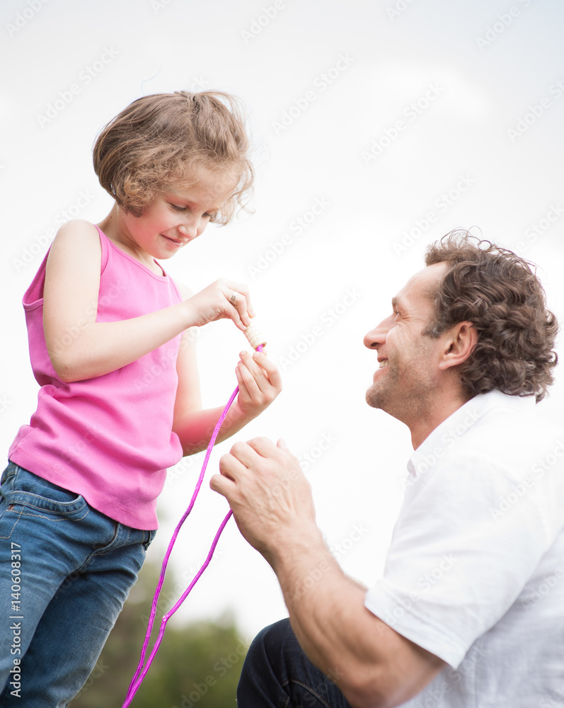 Father and daughter together with skipping rope Stock Photo | Adobe Stock