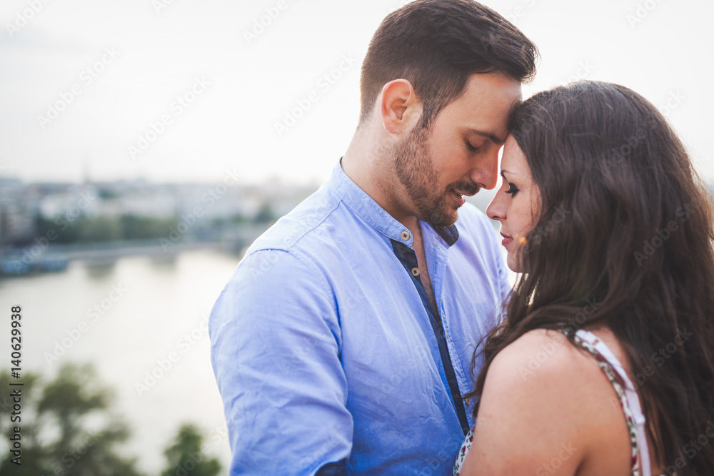 Romantic couple cuddling and kissing outdoors Stock Photo | Adobe Stock